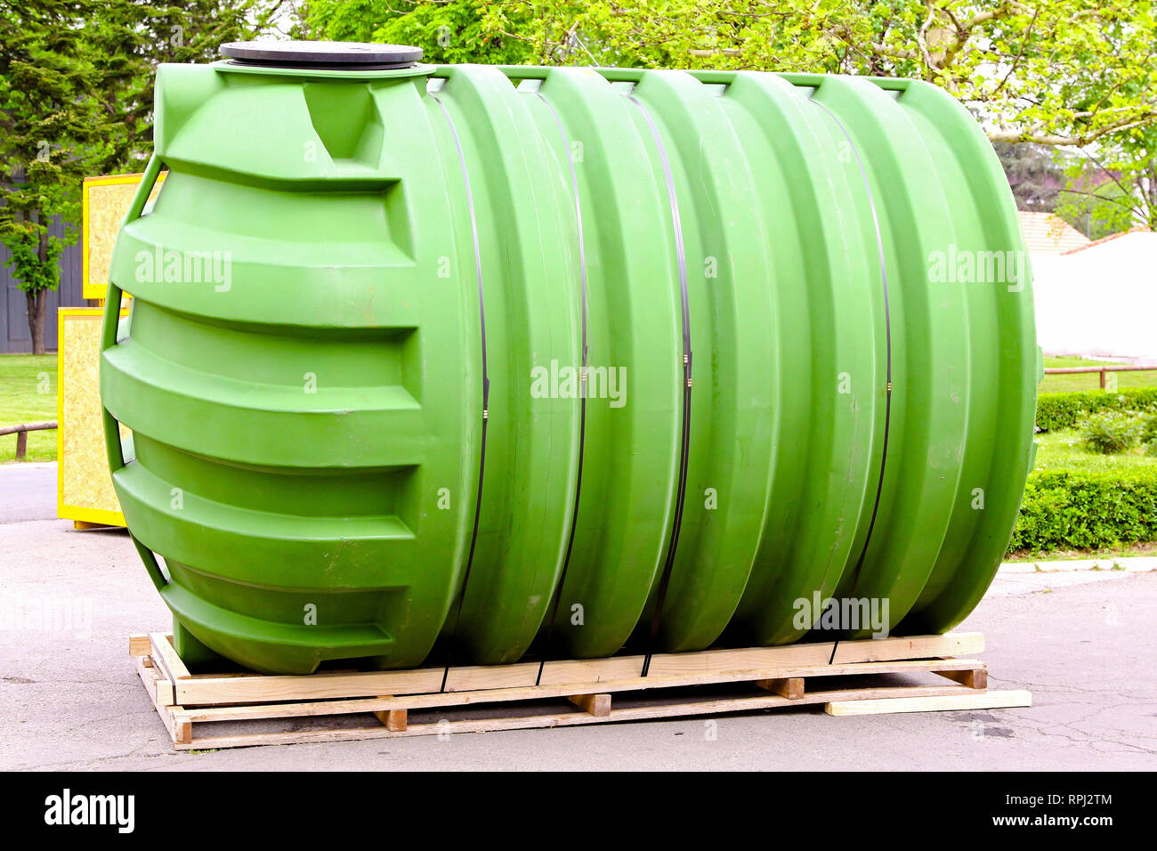 Big green tank for underground liquid storage Stock Photo - Alamy