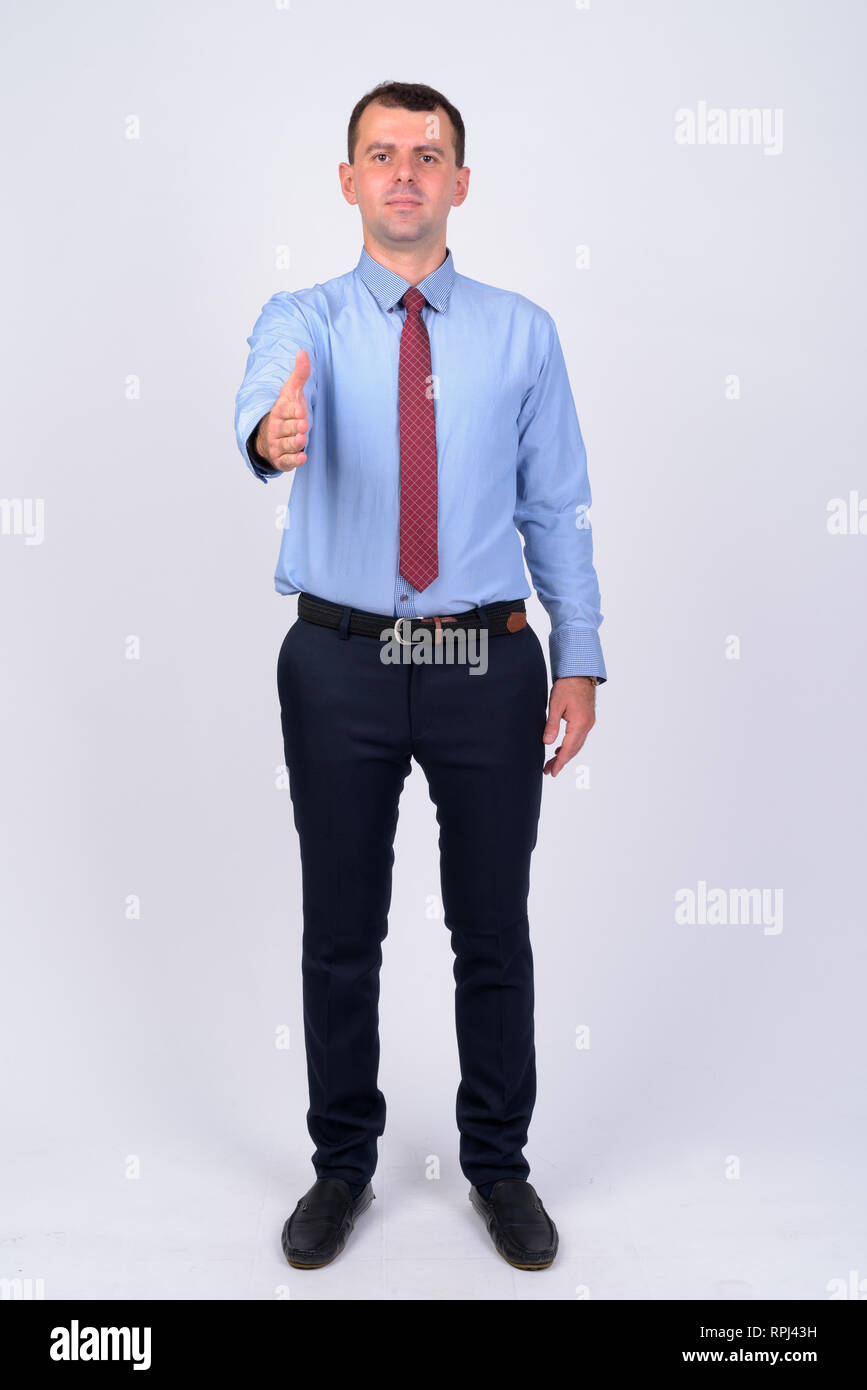Full body shot of businessman giving handshake Stock Photo - Alamy