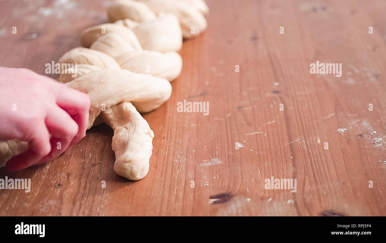 Step by step. Brading dough to bake fresh challah bread Stock Photo - Alamy
