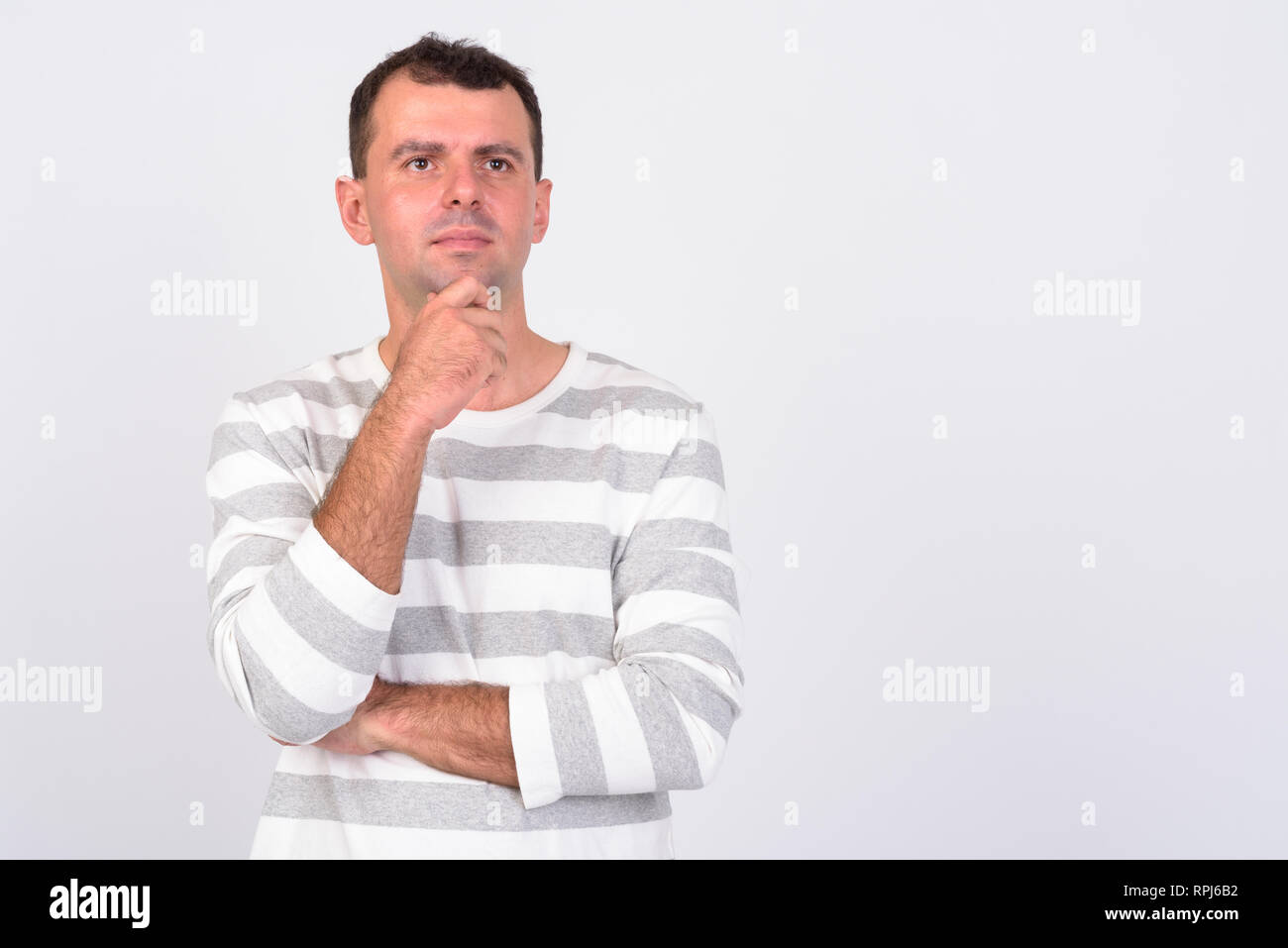 Portrait of man thinking against white background Stock Photo - Alamy