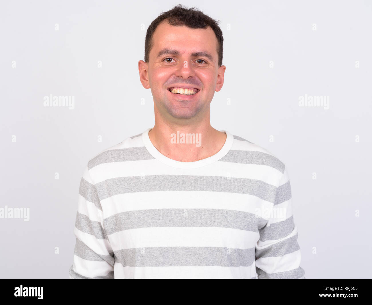 Face of happy man smiling against white background Stock Photo - Alamy