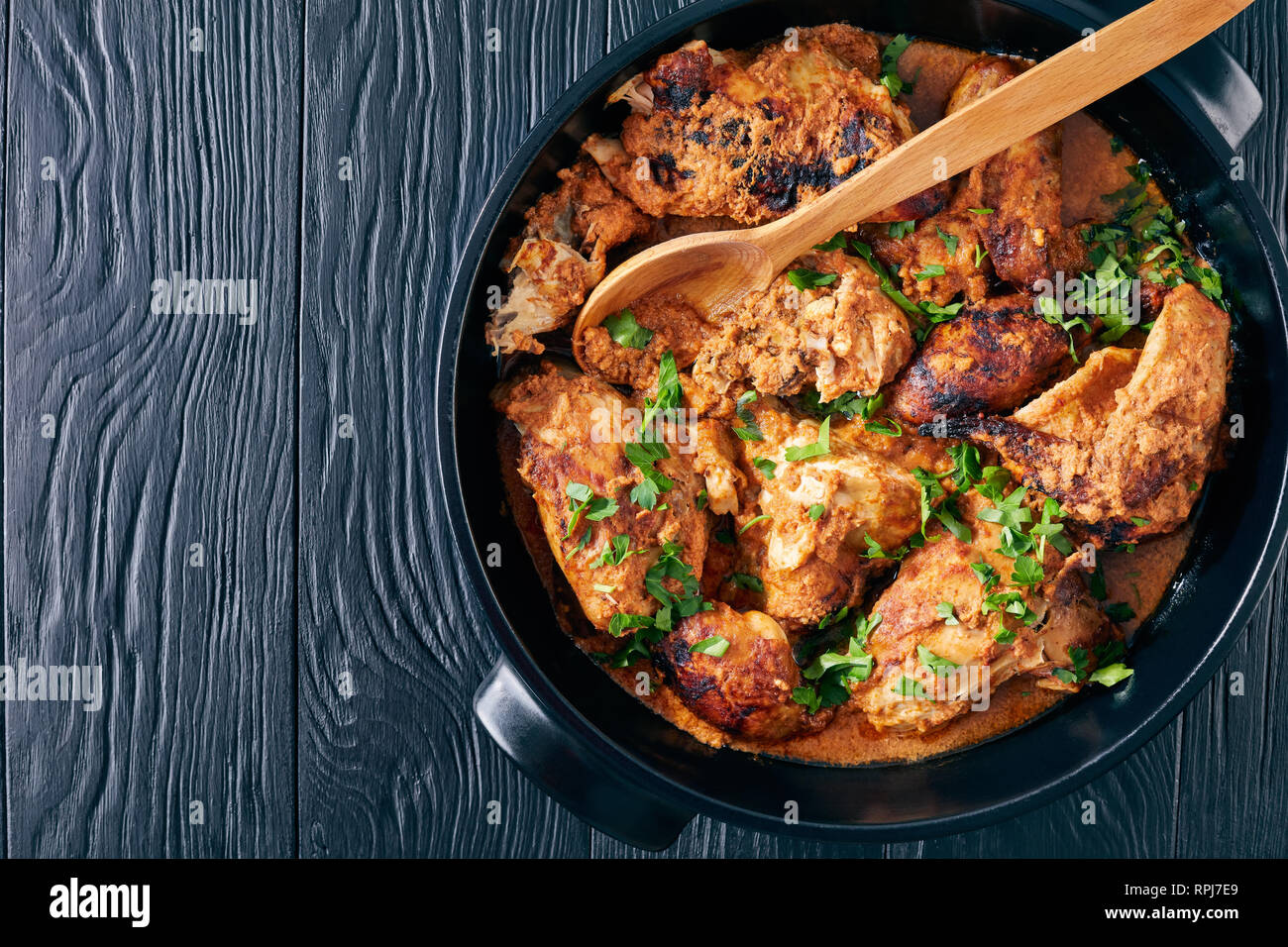 overhead view of Kuku Paka, Kenyan chargrilled Chicken in creamy spicy ...
