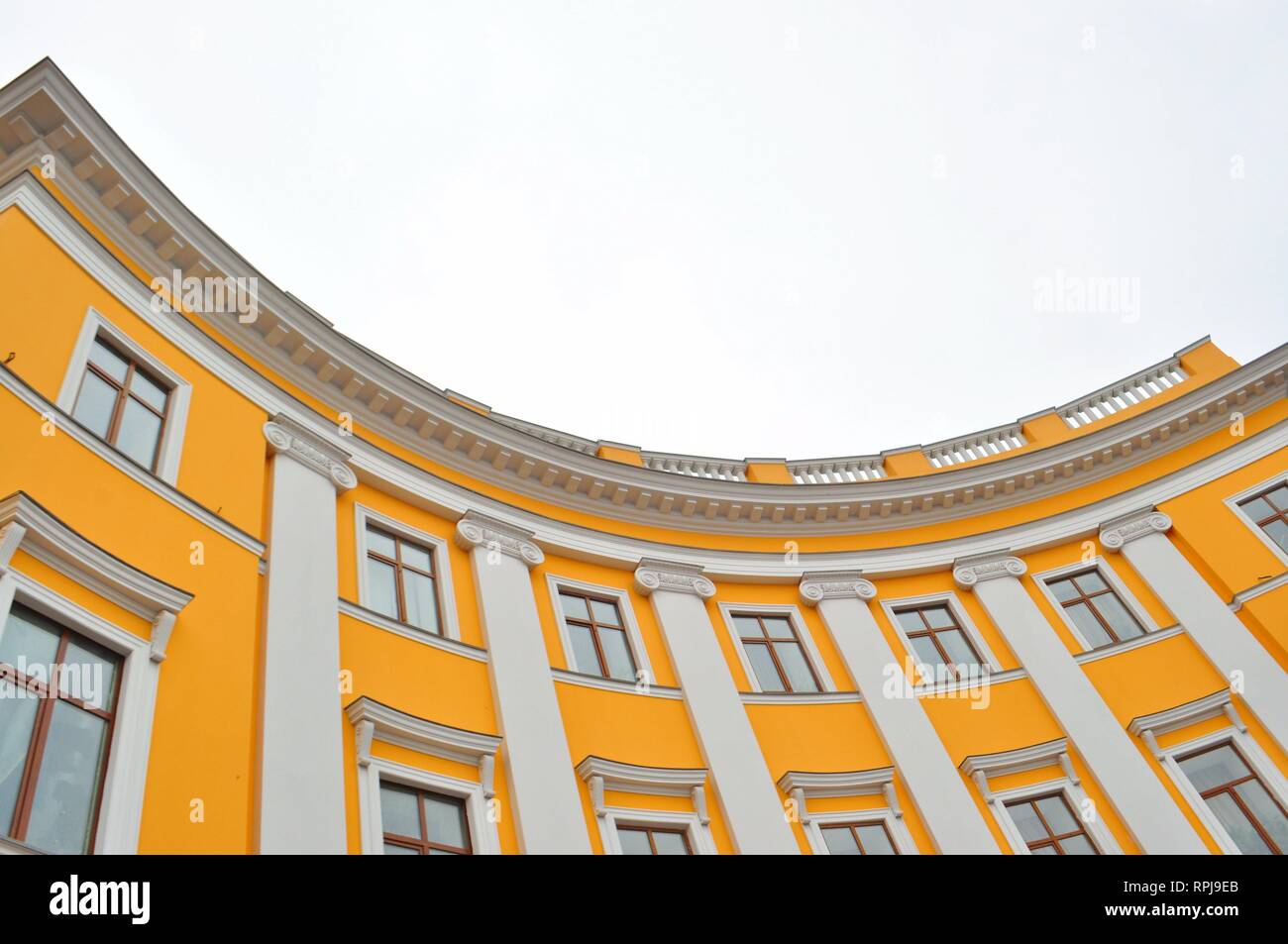 High angle view on a yellow color building. Looking up to bright color ...