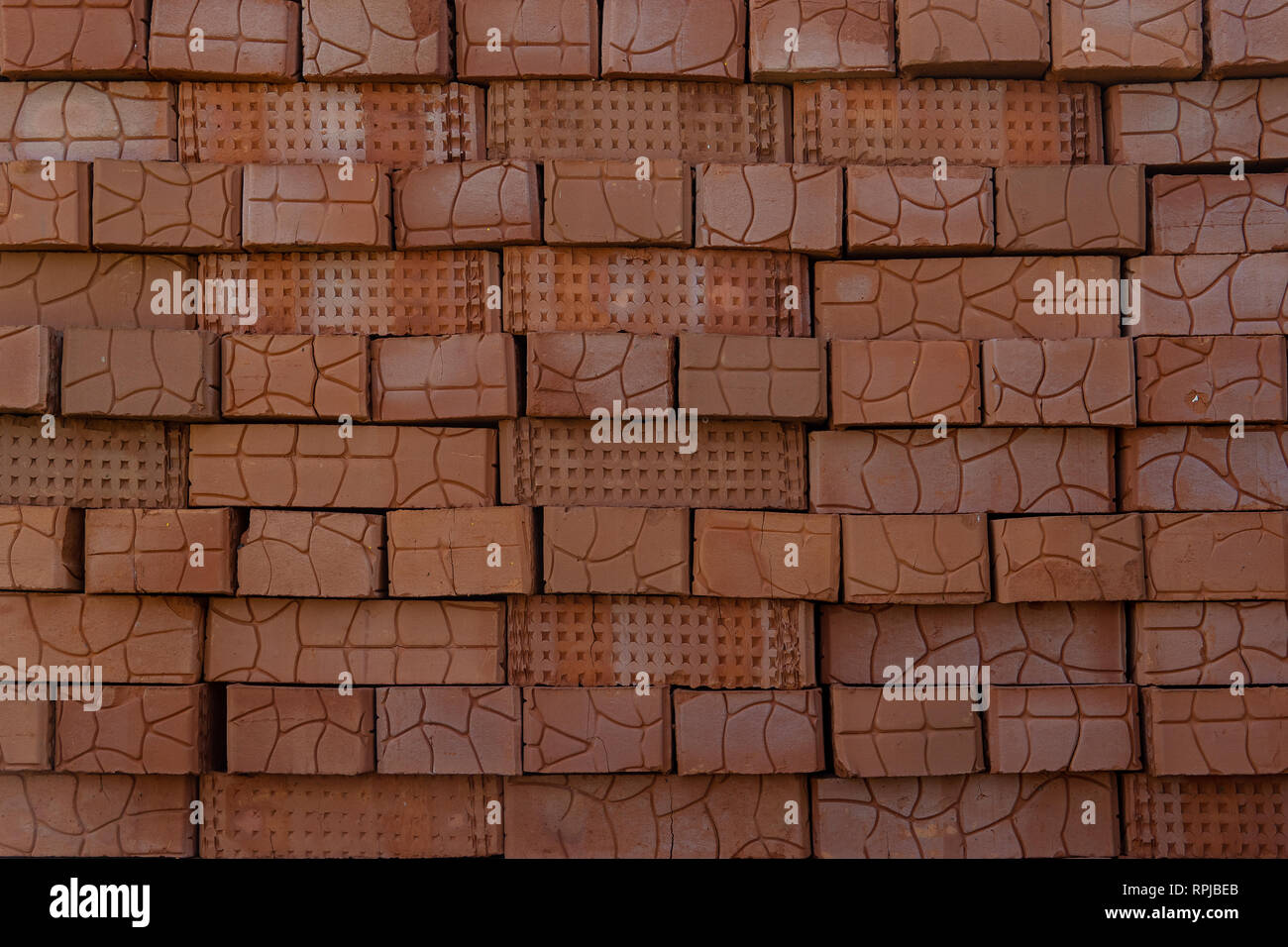 A stack of red clay bricks, background Stock Photo - Alamy