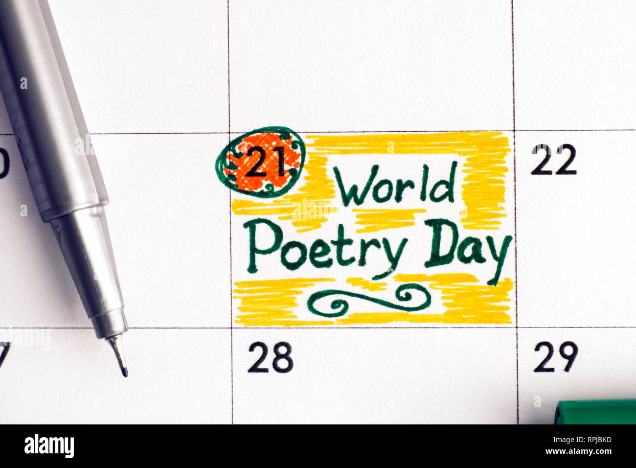 Reminder World Poetry Day in calendar with green pen. 21 March. Close ...