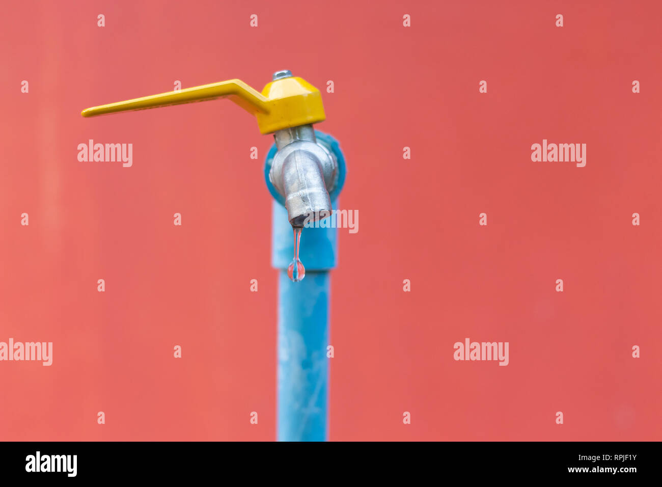 water drop faucet on brick wall background Stock Photo - Alamy