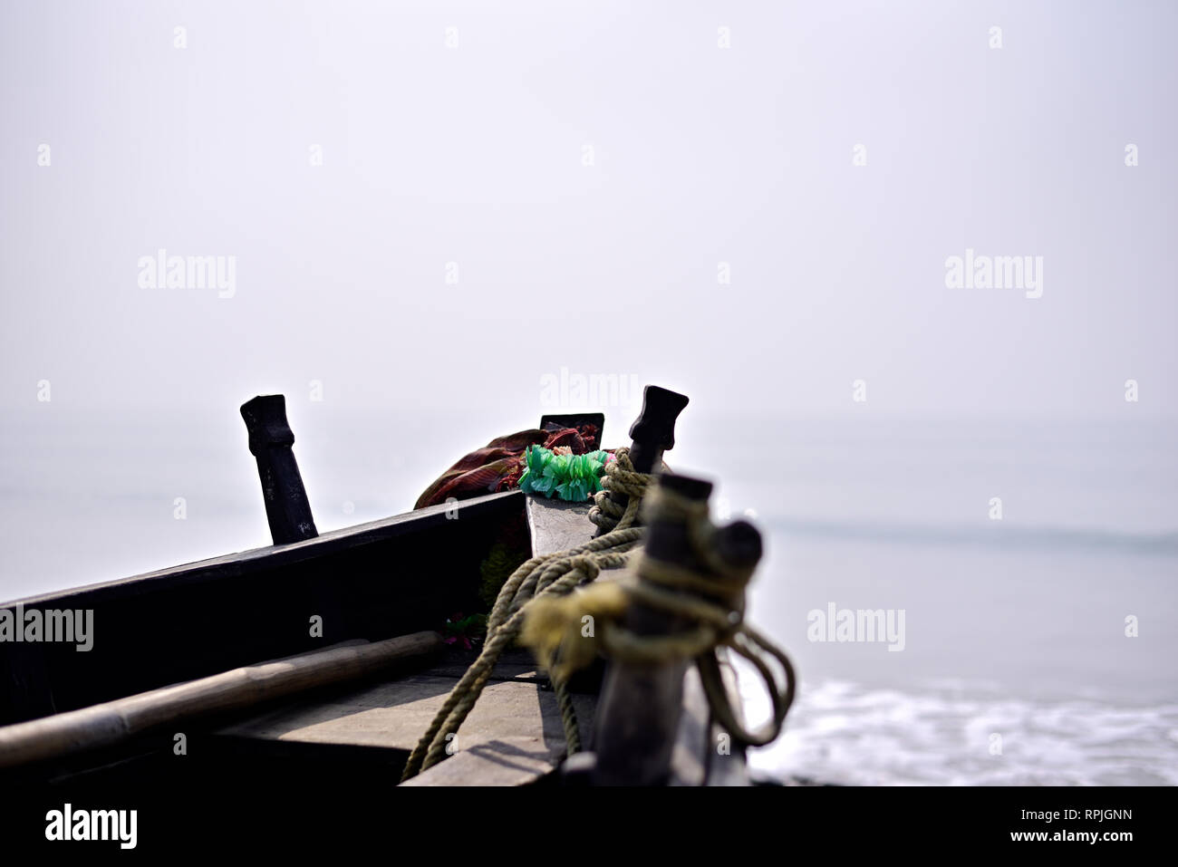 Close-up of empty fishing boat in sea beach Stock Photo - Alamy
