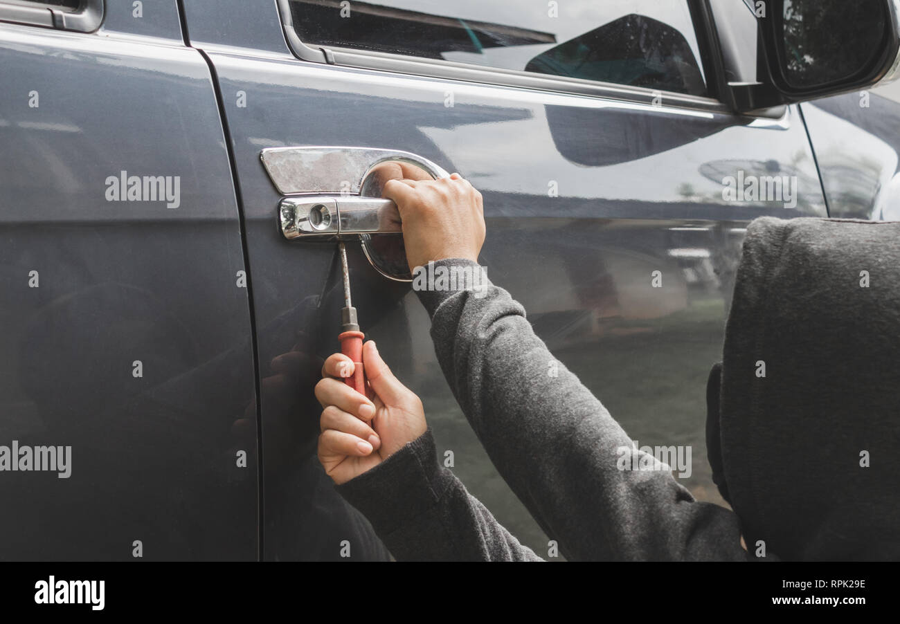 Man burglar stealing car Stock Photo - Alamy
