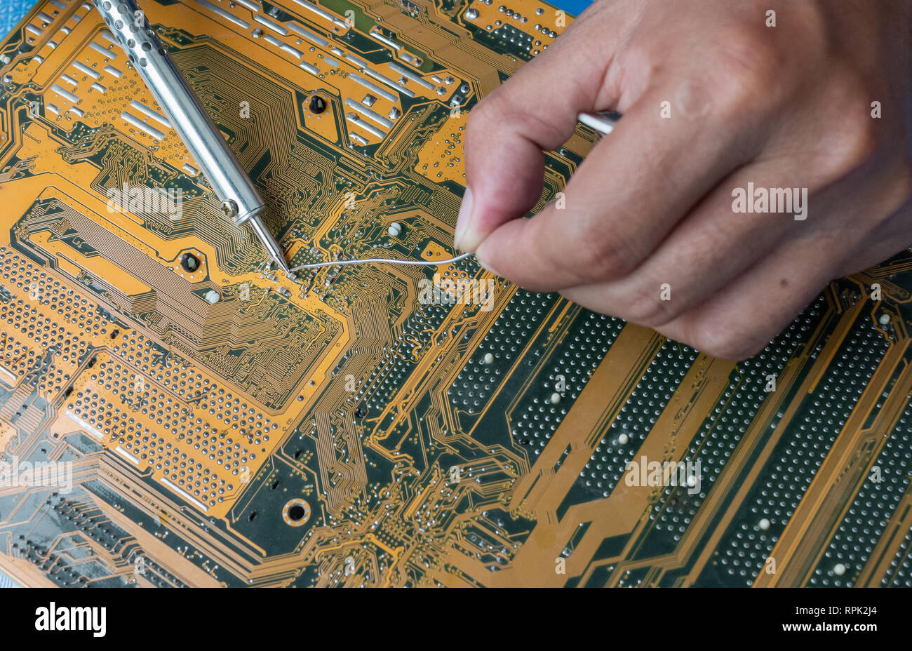 The technician repairing the computer mainboard by soldering top view Stock Photo - Alamy