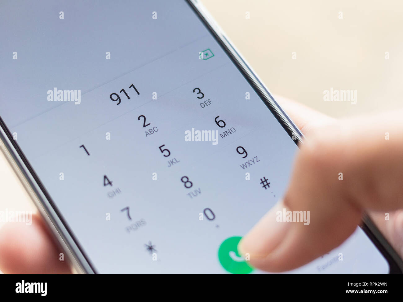 Emergency and urgency, dialing 911 on smartphone screen. Shallow depth ...