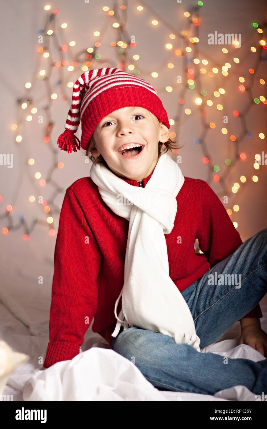 smiling boy in christmas hat colourful background Stock Photo - Alamy