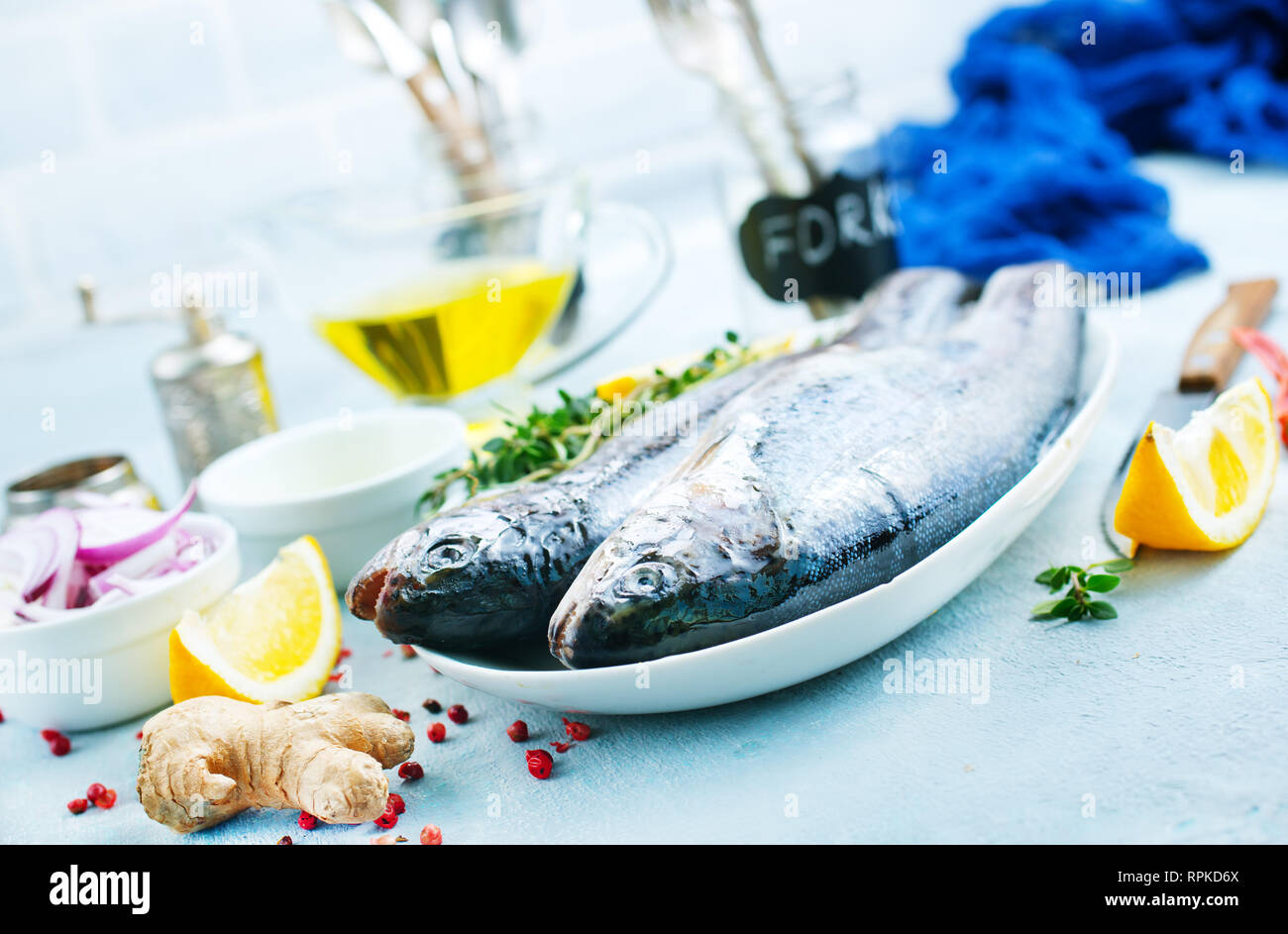 raw fish on board and on a table Stock Photo - Alamy