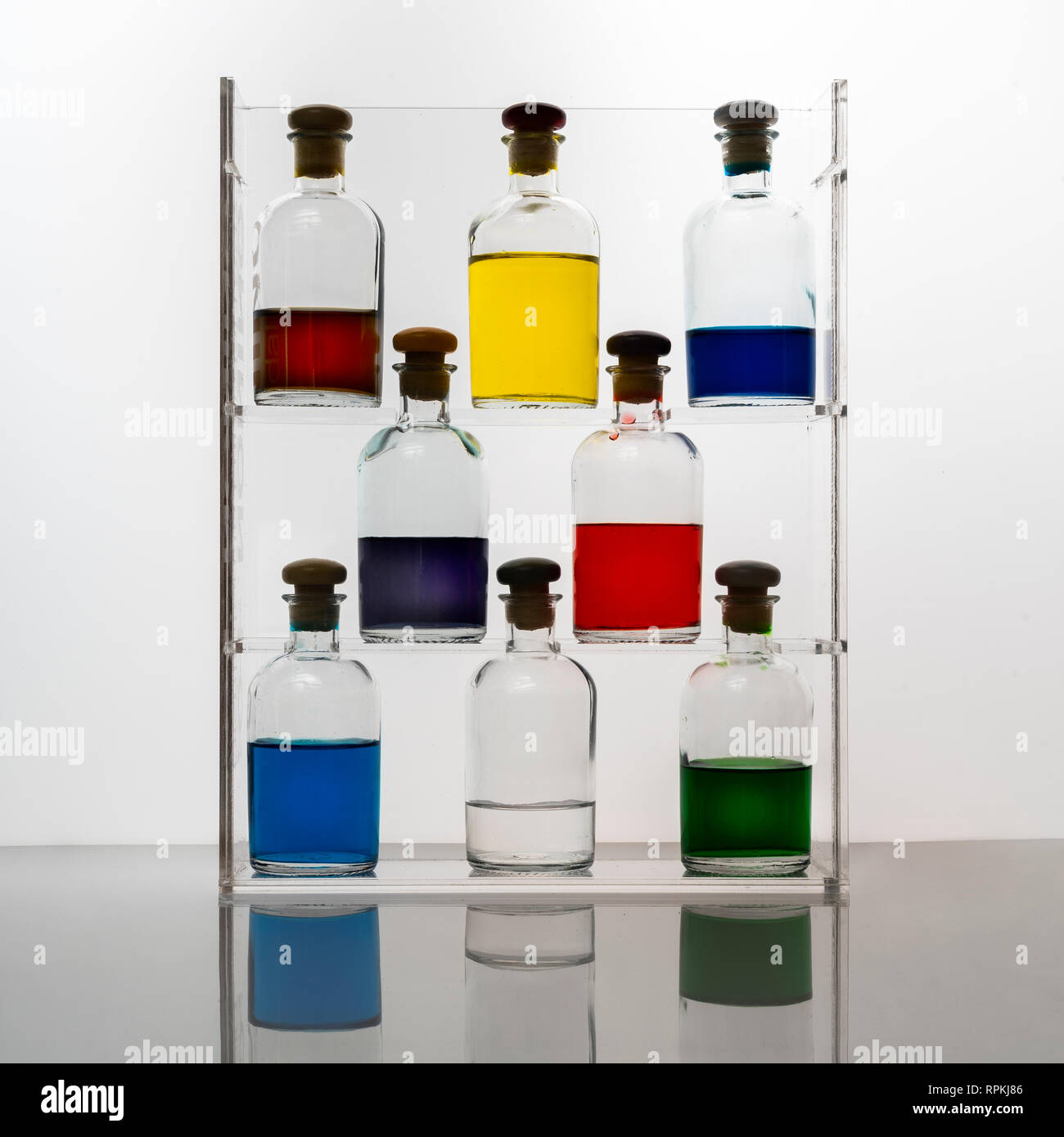 Small glass bottles containing colored liquid Stock Photo - Alamy