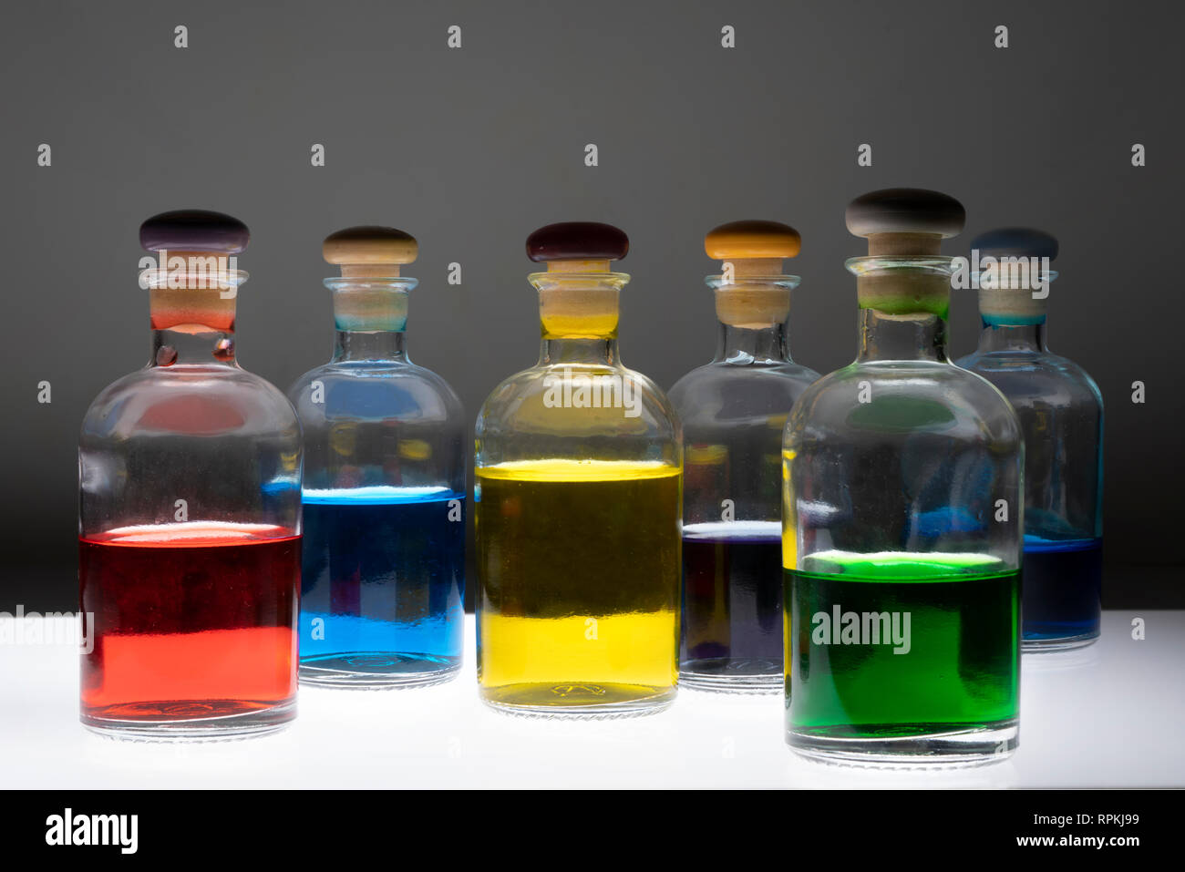 Small glass bottles containing colored liquid Stock Photo - Alamy