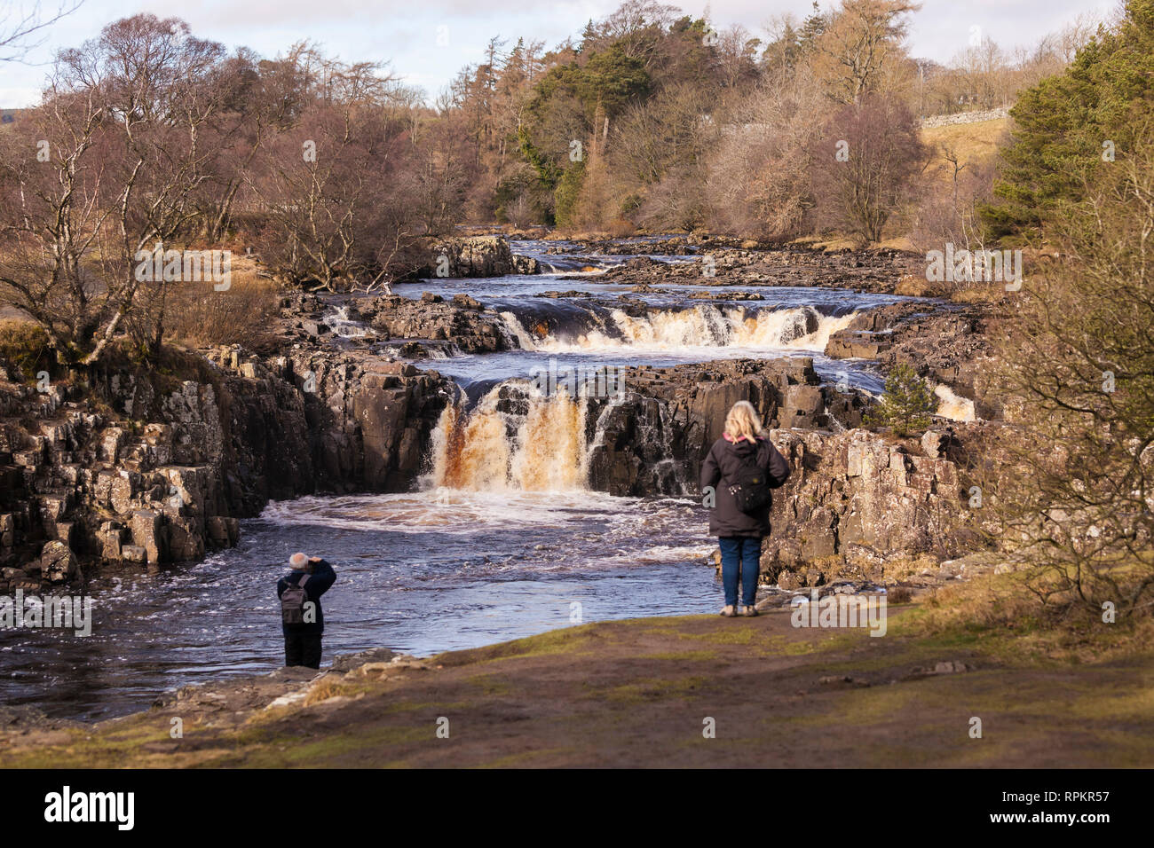 People admiring the views and taking photographs at the waterfalls at ...