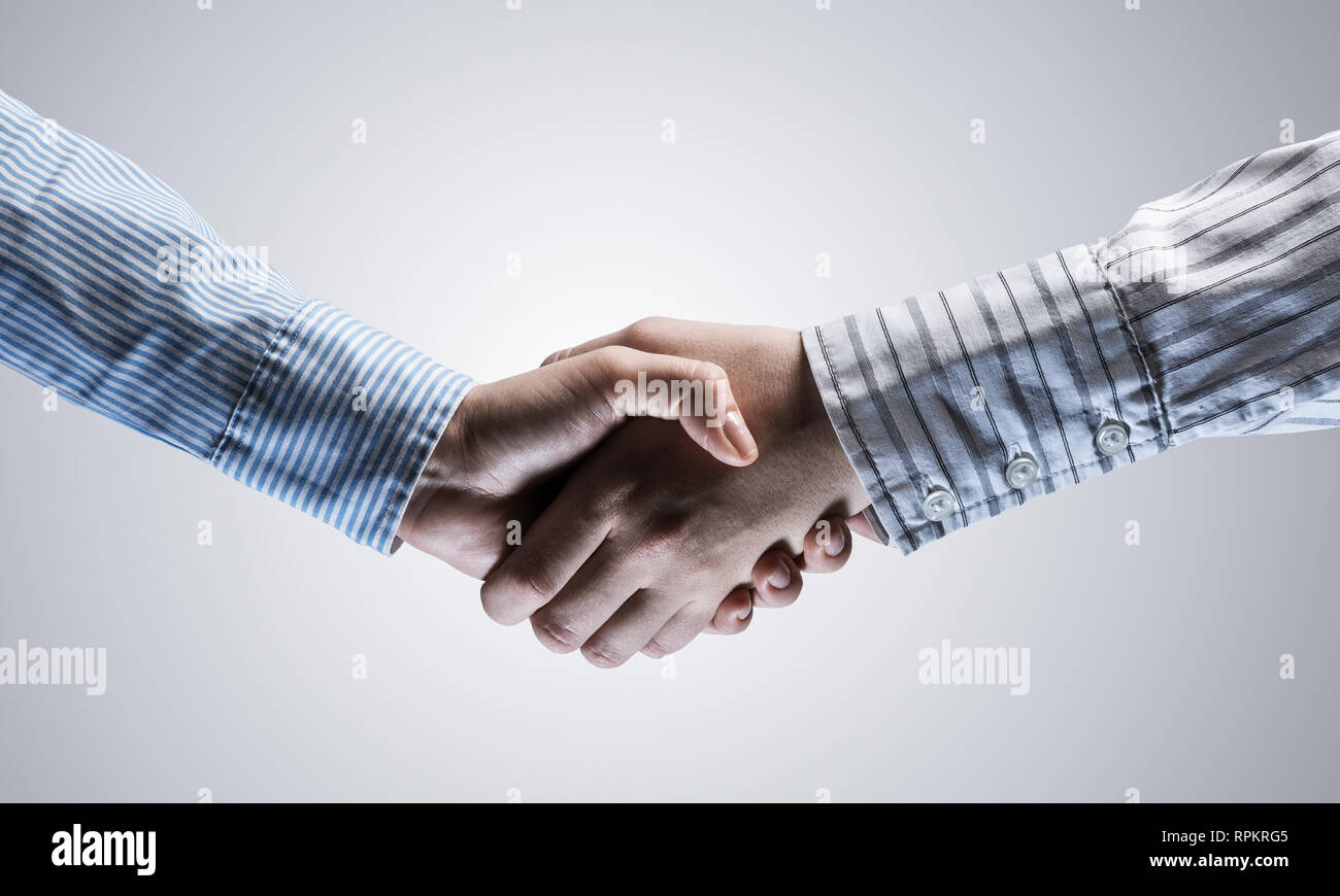 Business handshake as idea for unity and cooperation or greeting. Mixed ...