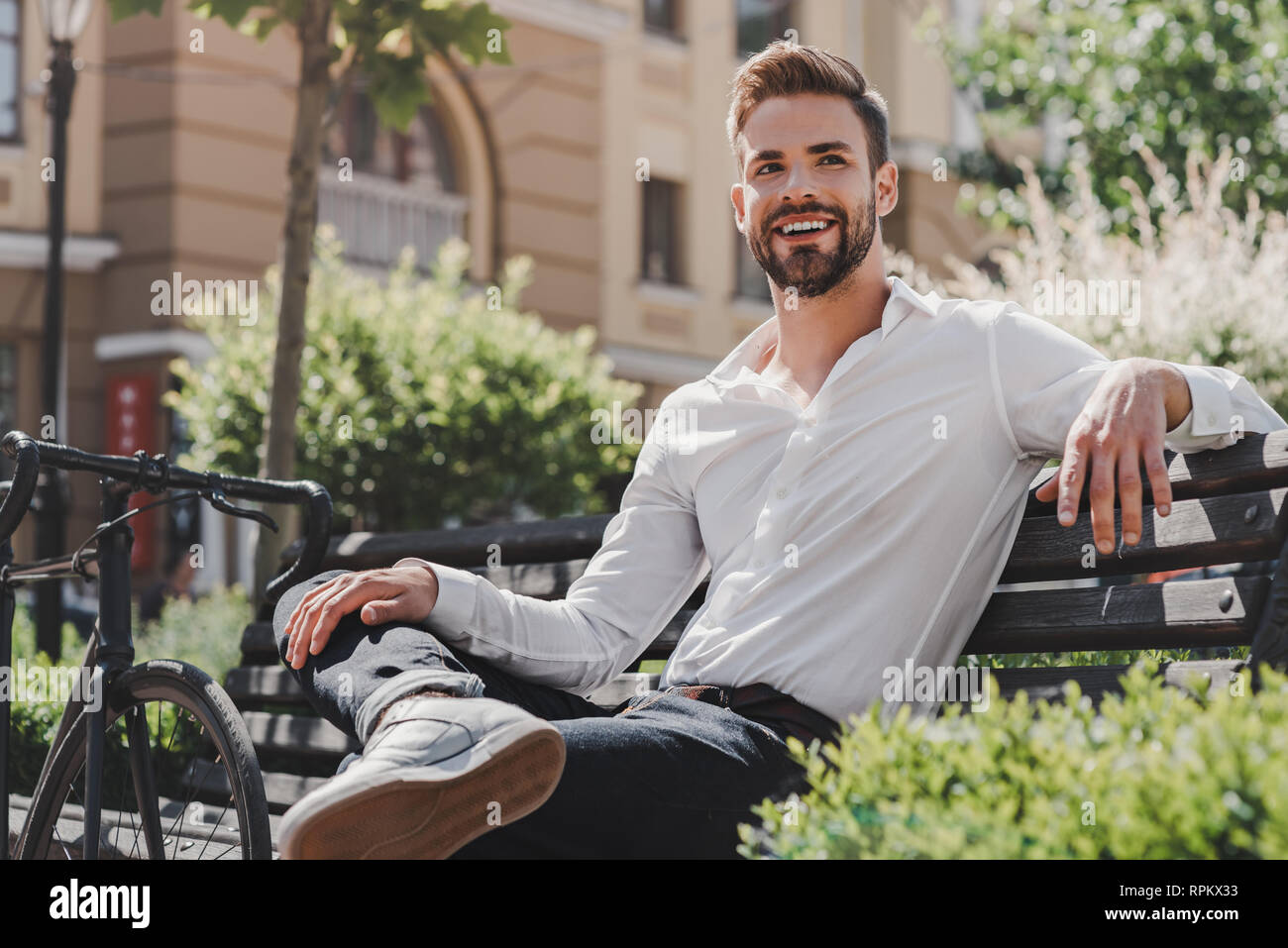 Person sitting on street bench city hi-res stock photography and images ...