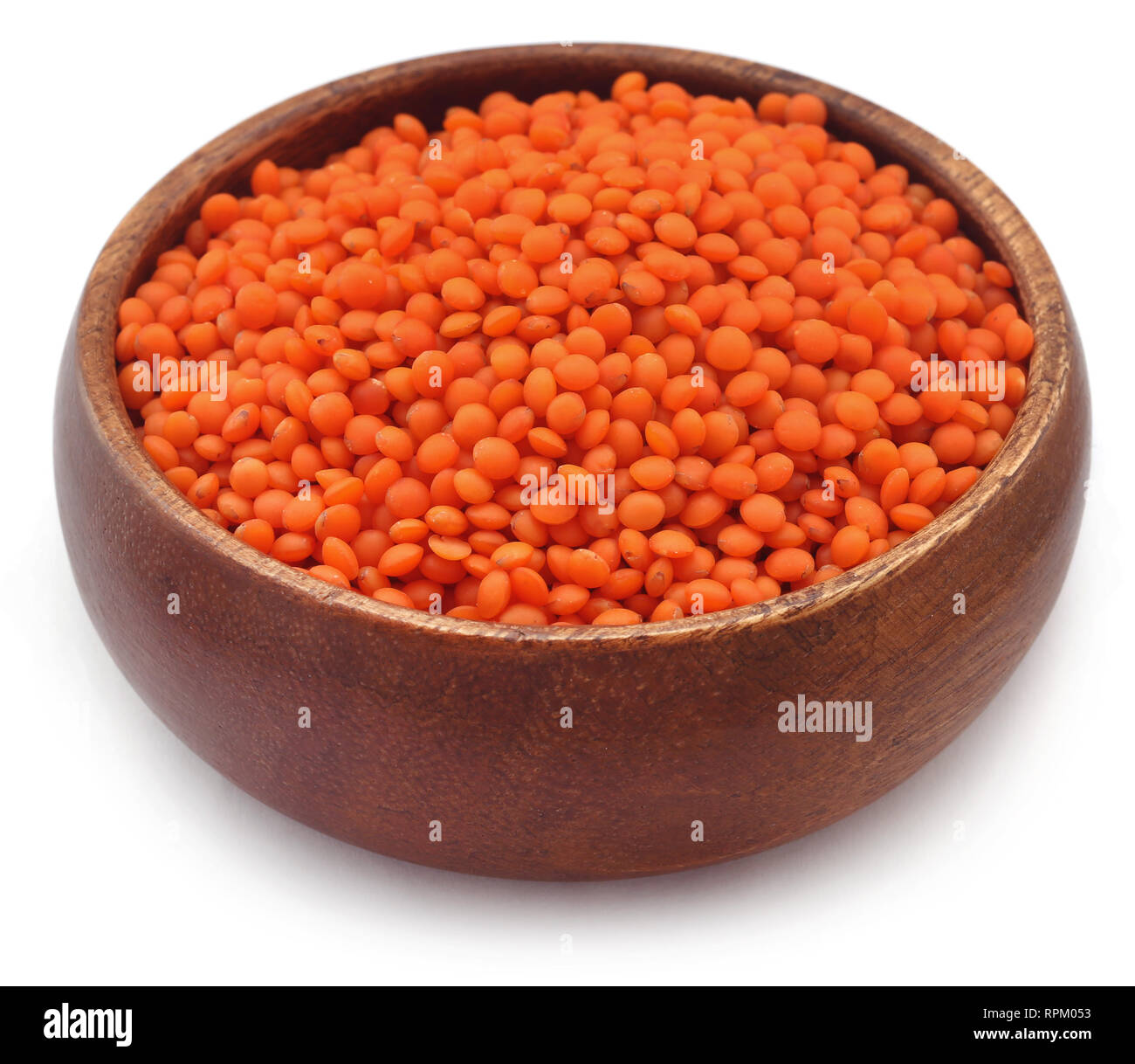 Pile of some fresh lentil in wooden bowl over white background Stock ...