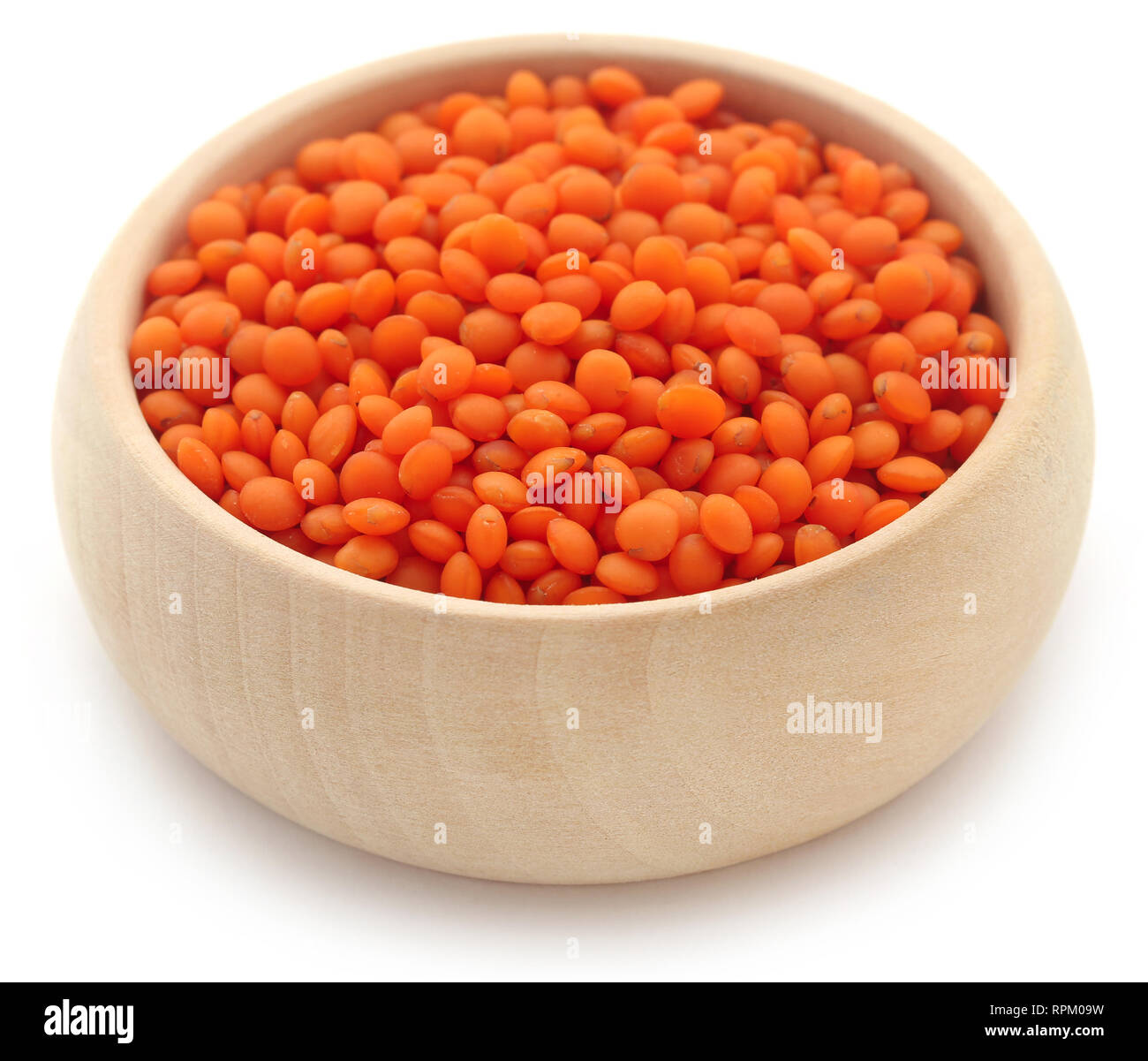 Pile of some fresh lentil in wooden bowl over white background Stock ...