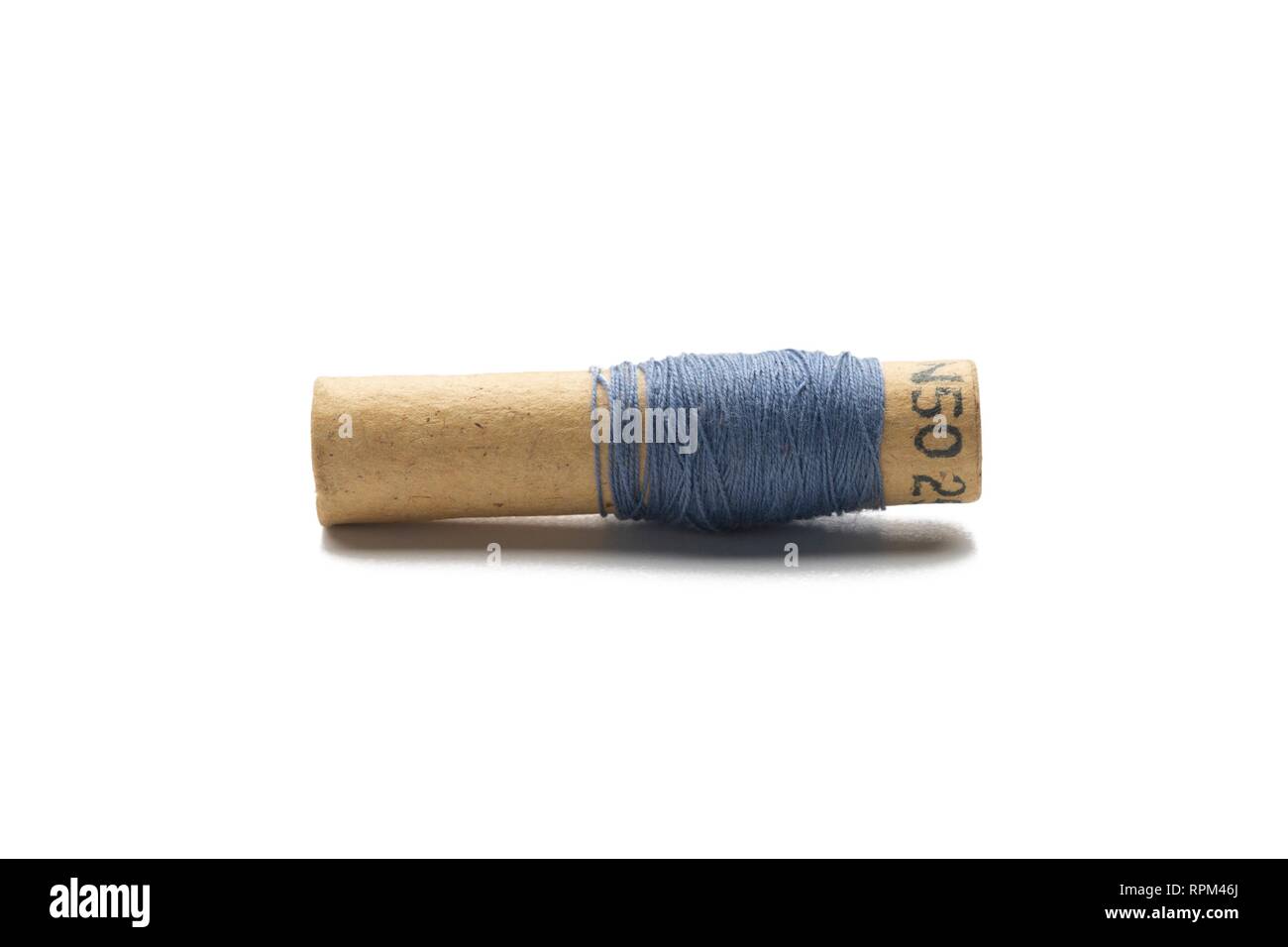 Not full used thread spool single white background Stock Photo - Alamy