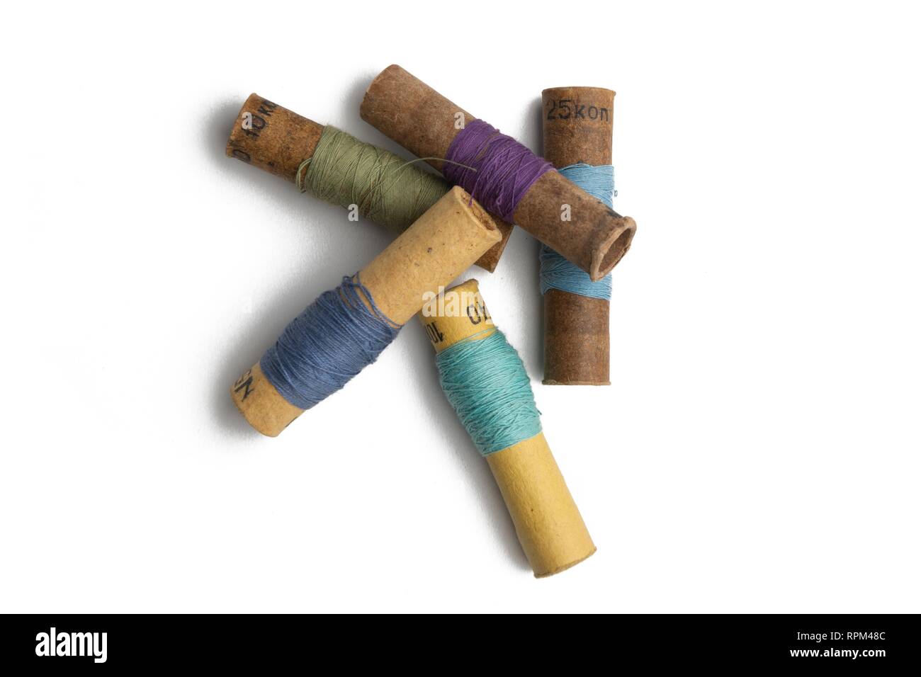 Not full used retro group of thread spools white background with ...