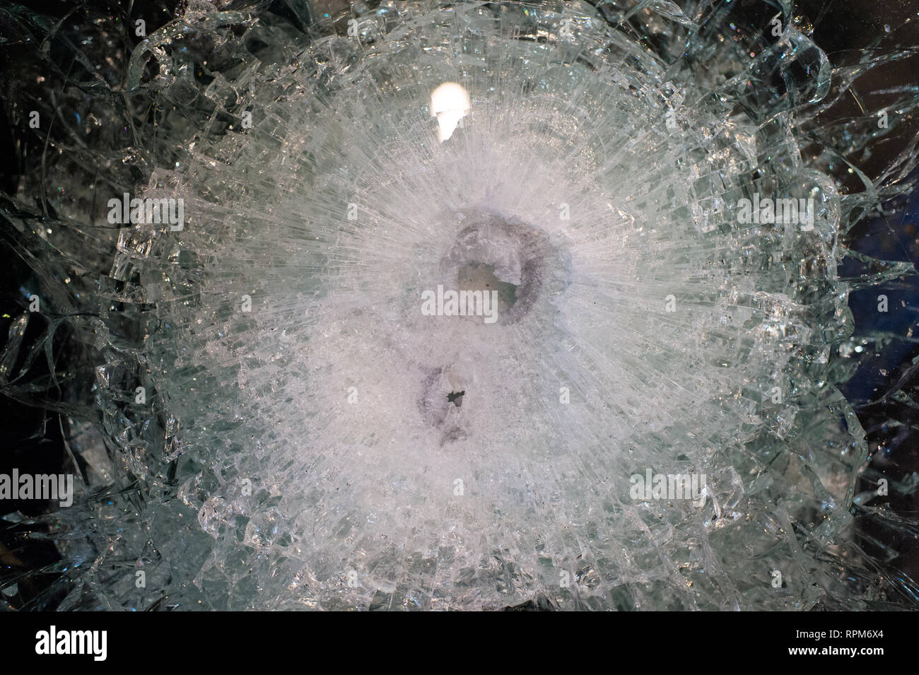Bulletproof glass after gunshot, close up. Bulletproof glass destroyed ...