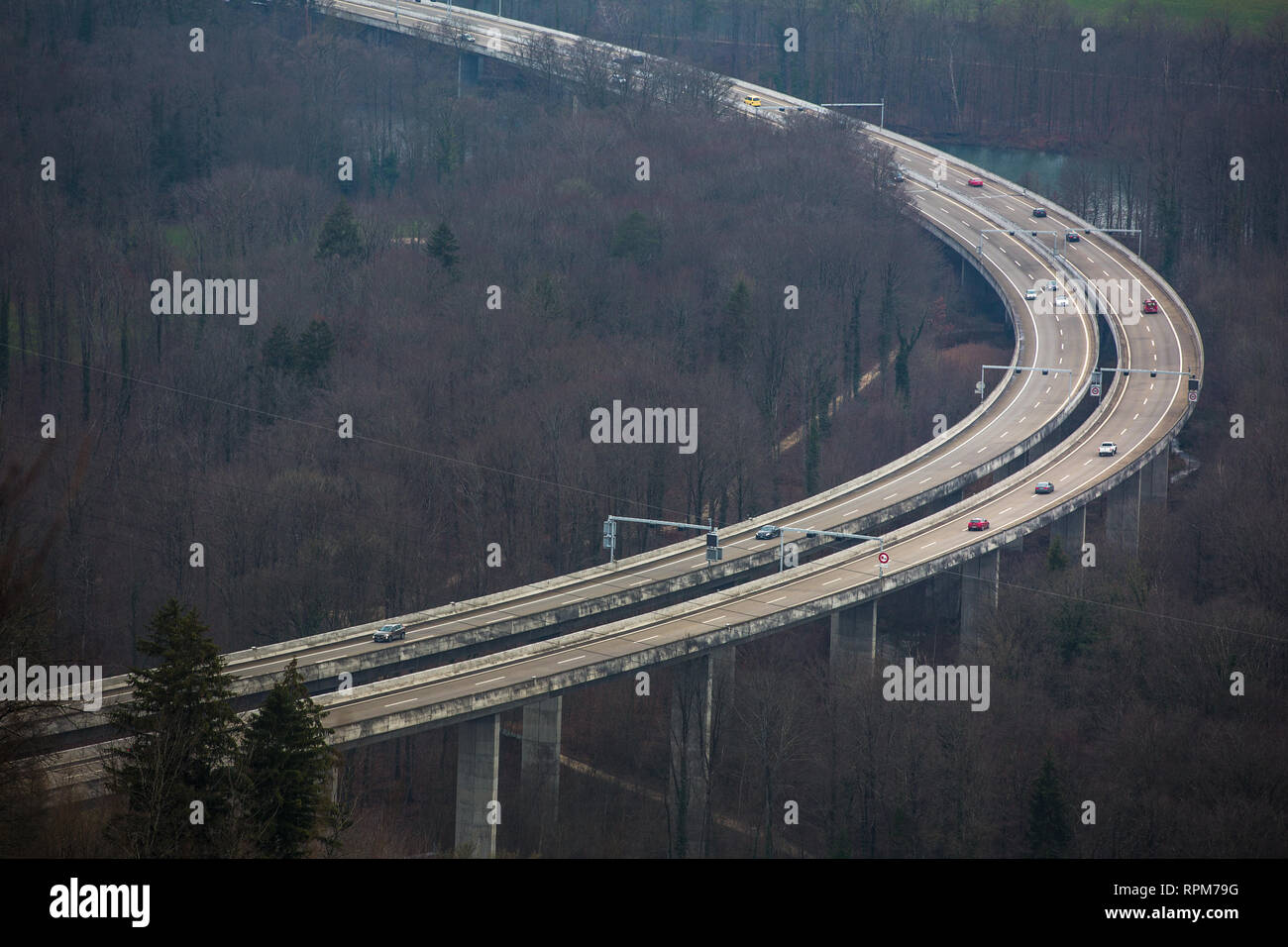 Highway on columns in a valley from afar and above - light traffic ...