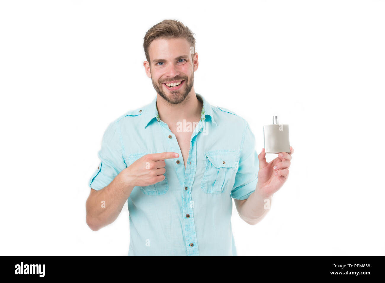 Happy man point finger at perfume bottle. Bearded man smile with ...