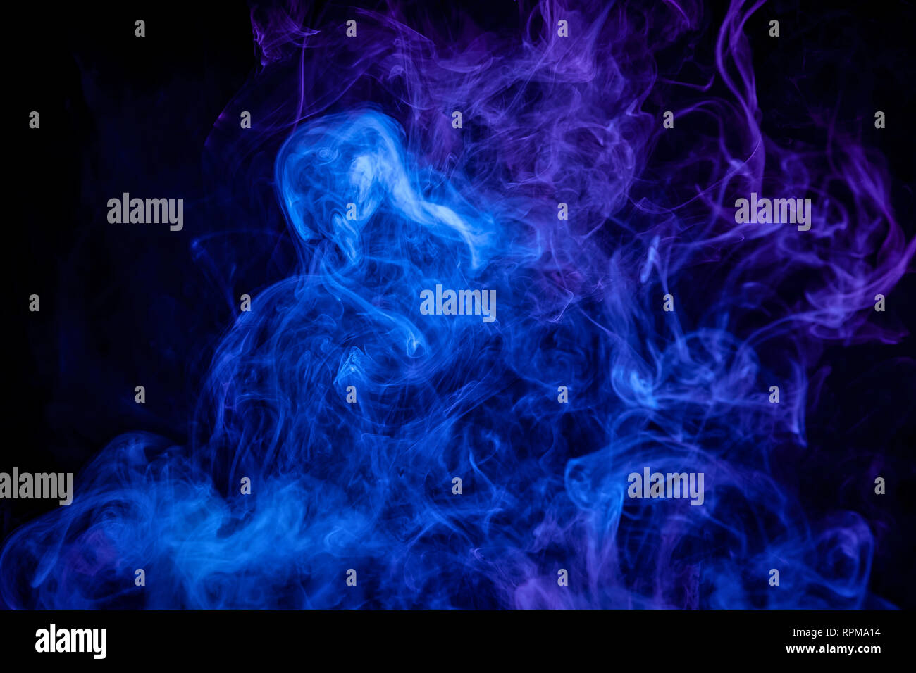 Blue and purple bomb smoke on black isolated background Stock Photo - Alamy