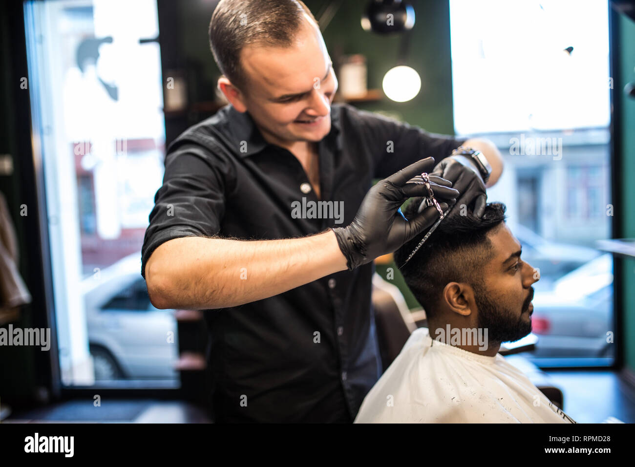 Young handsome guy cuts hair, man cuts hair in barbershop Stock Photo ...