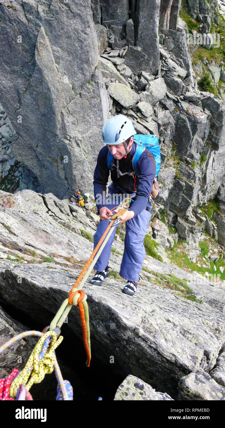 rock climbers traverse and climb the Clocher de Planpraz climbing route ...