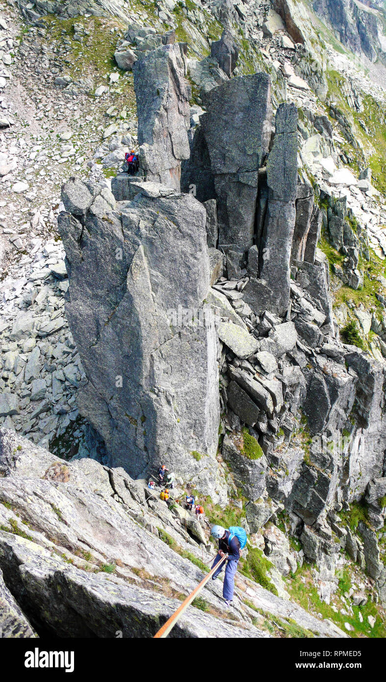 rock climbers traverse and climb the Clocher de Planpraz climbing route ...