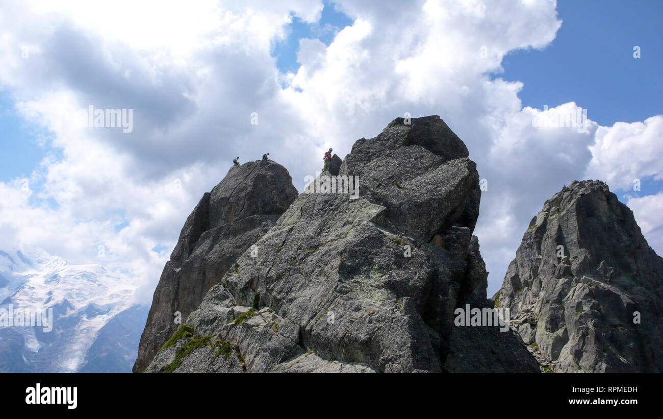 rock climbers traverse and climb the Clocher de Planpraz climbing route ...