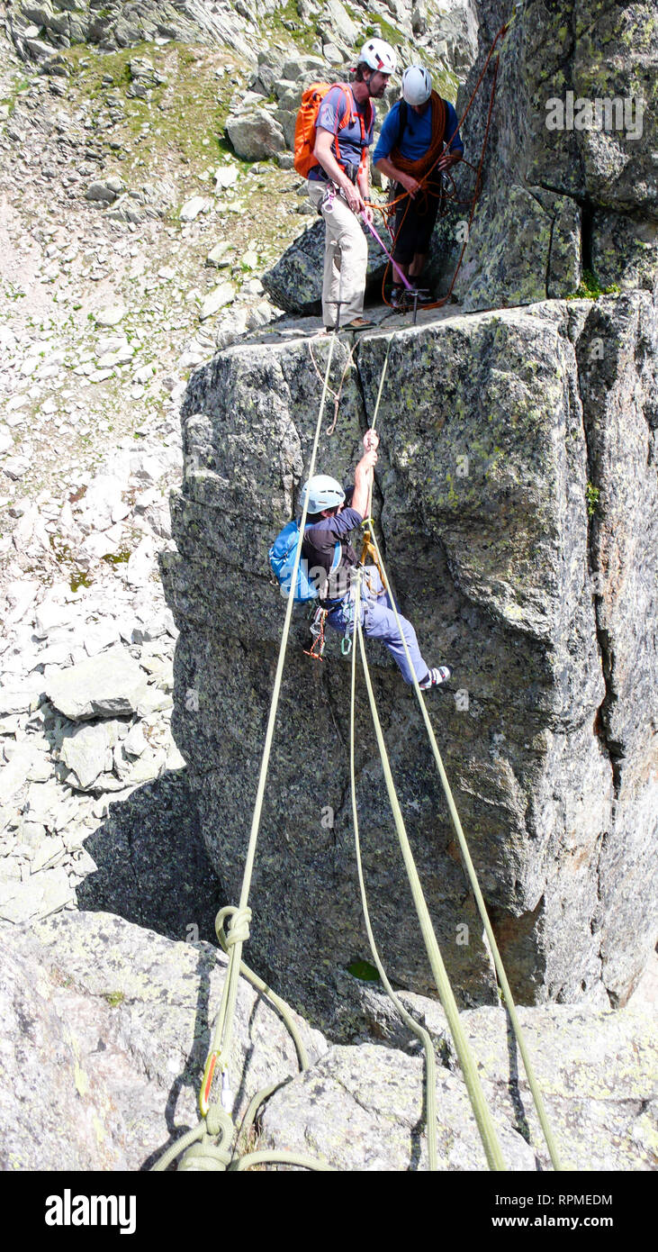 rock climbers traverse and climb the Clocher de Planpraz climbing route ...