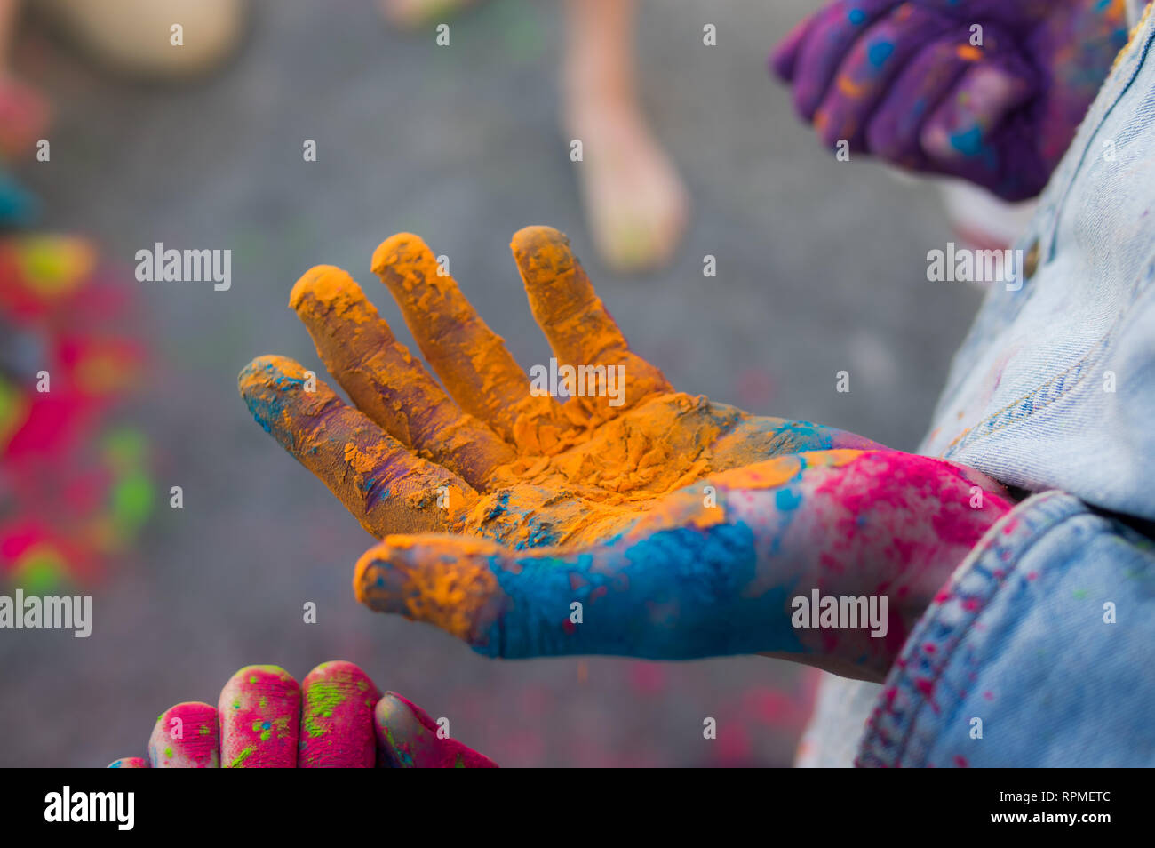 Three hands with multicolor dry hawley paint Stock Photo - Alamy