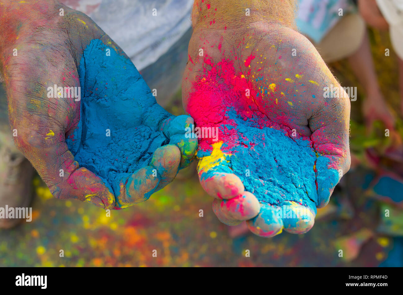Two hands with multicolor dry hawley paint Stock Photo - Alamy