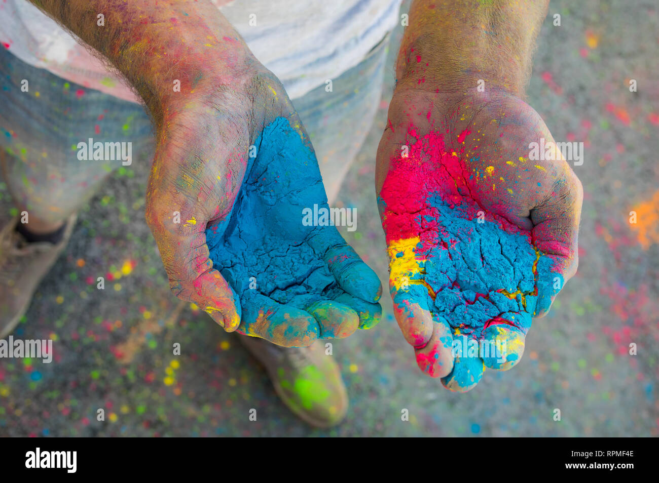 Two hands with multicolor dry hawley paint Stock Photo - Alamy