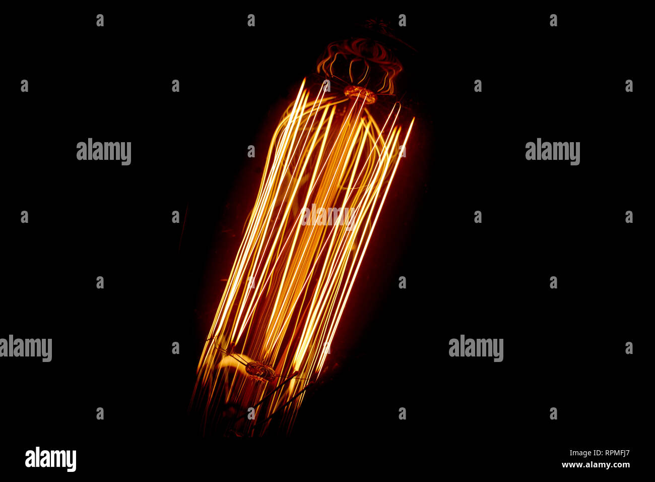 Close up of angled Edison style bulb filaments set against a black ...