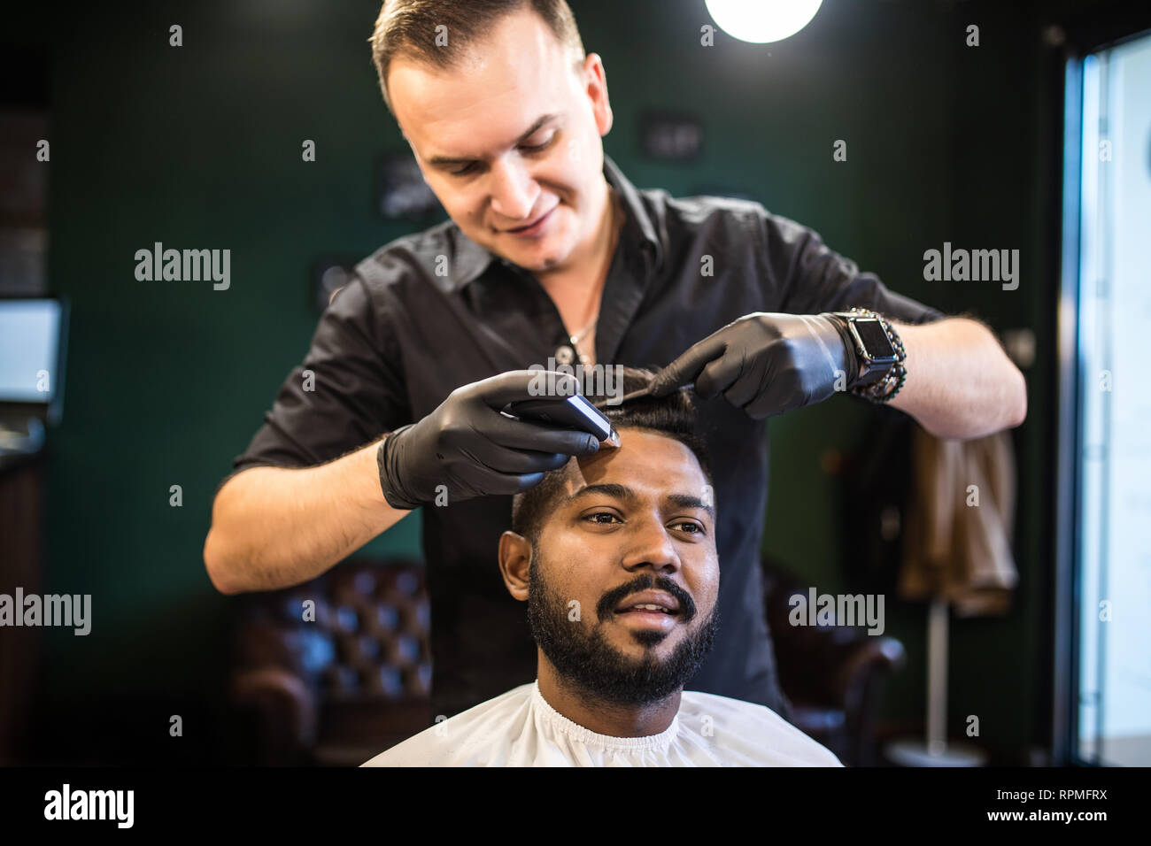 Unshaven man being clipped with professional electric shearer machine ...