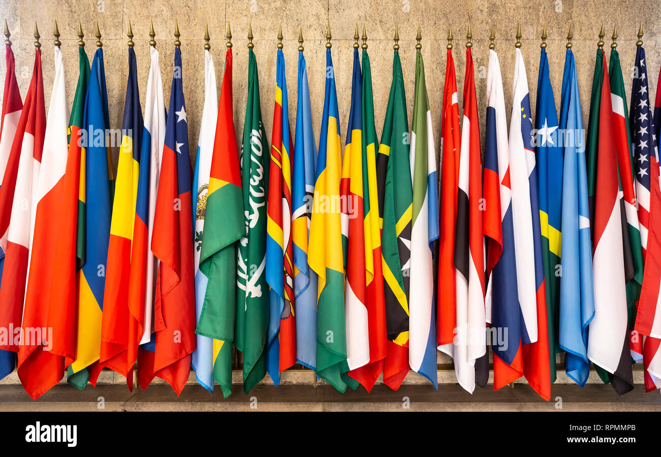 Some world national flags on poles on a wall Stock Photo - Alamy