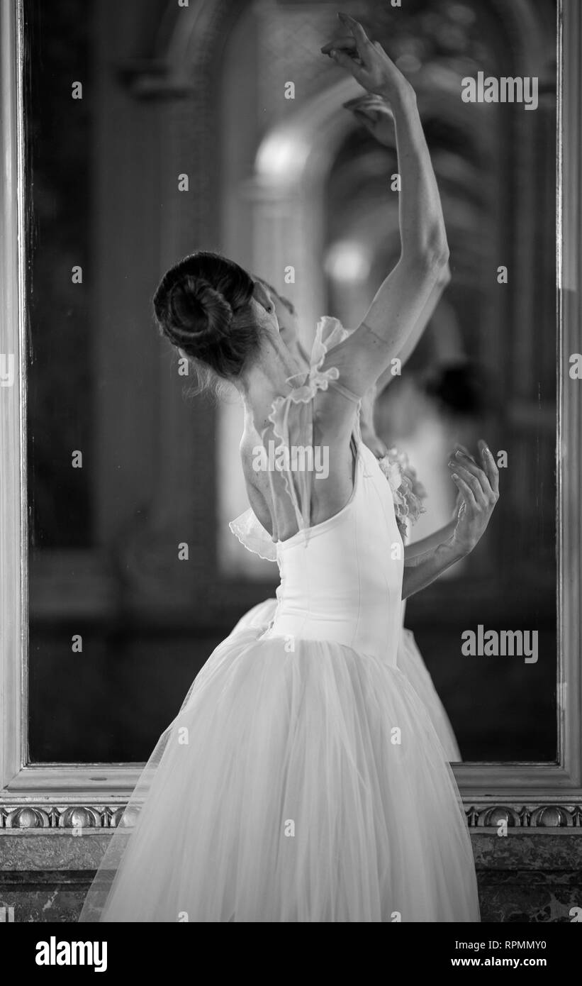 Beautiful ballerina dancing in front of the mirror. Black and white ...