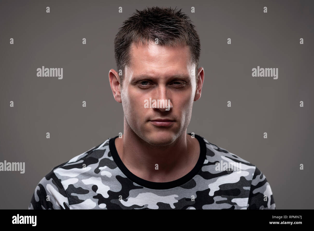 Dramatic moody close up portrait of angry young adult man with intense ...