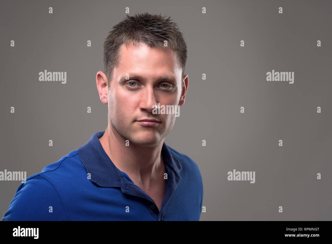 Close up portrait of suspicious young man with intense stare at camera ...