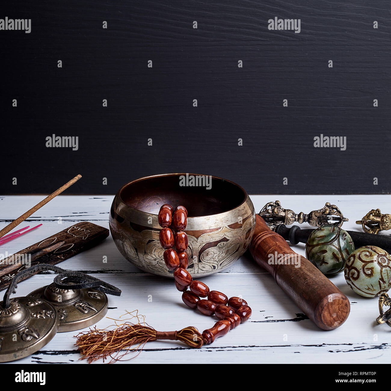 Copper singing bowl, prayer beads, prayer drum, stone balls and other ...