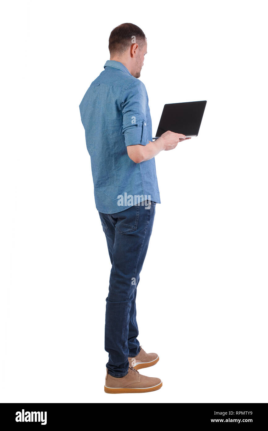 Back view of a man who is standing with a laptop. Rear view people ...