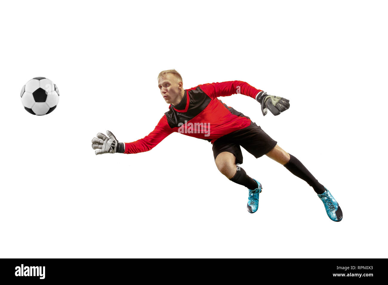 Male soccer player goalkeeper catching ball in jump. Silhouette of fit ...