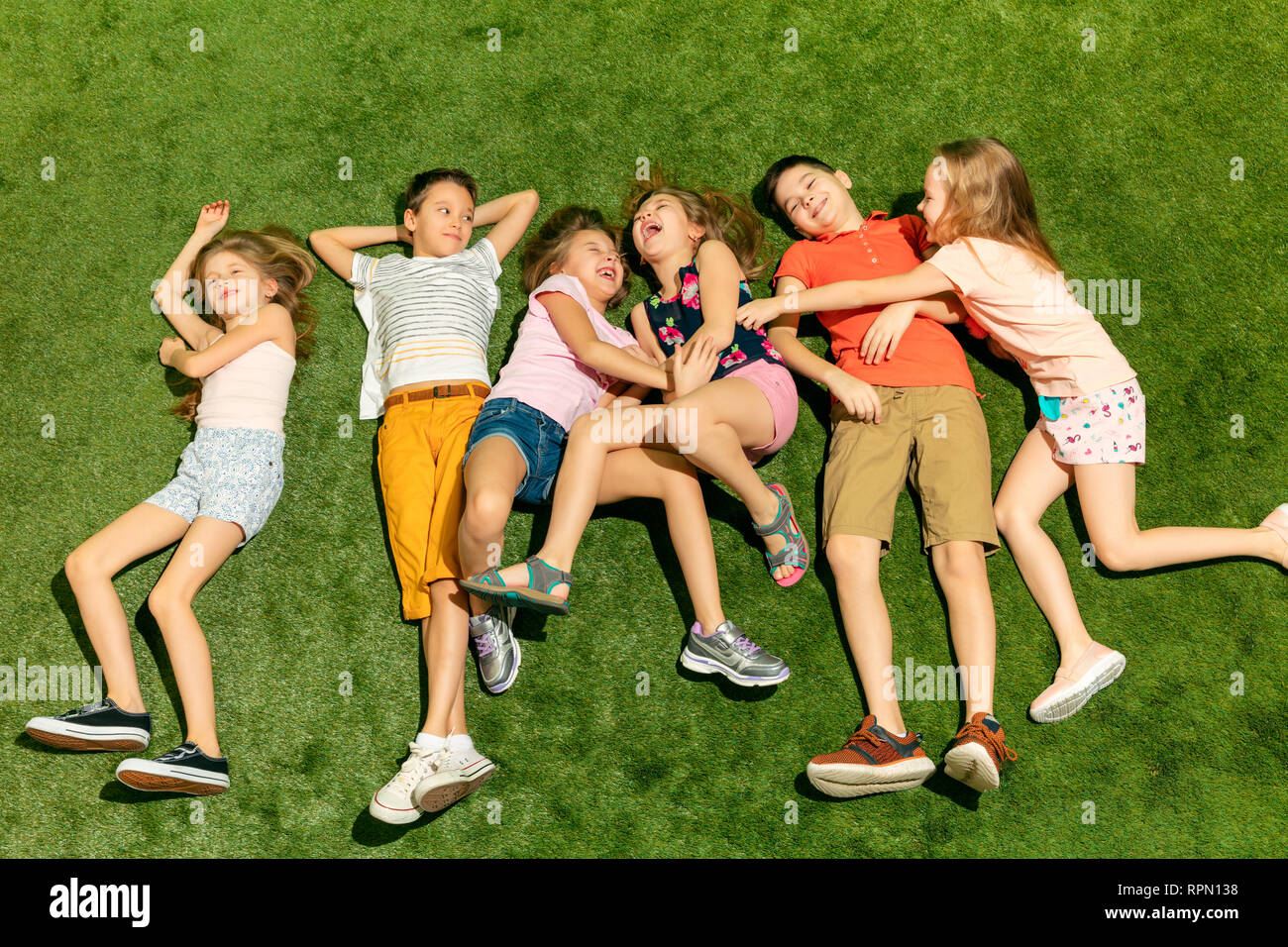 Group of happy children playing outdoors. Kids having fun in spring ...