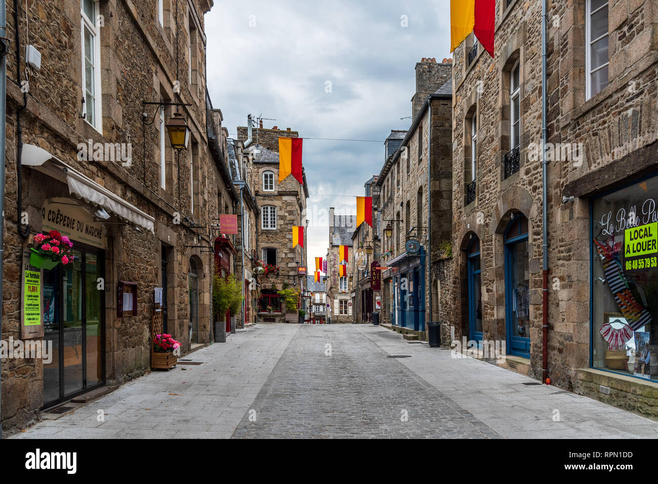 Dinan, France - July 24, 2018: Old cobblestoned street with timber ...