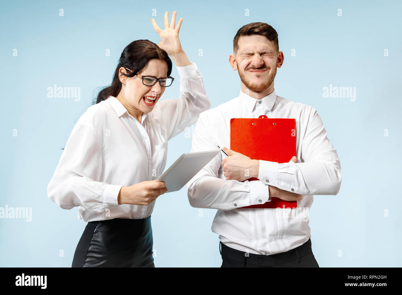 Angry boss. Woman and his secretary standing at office or studio ...