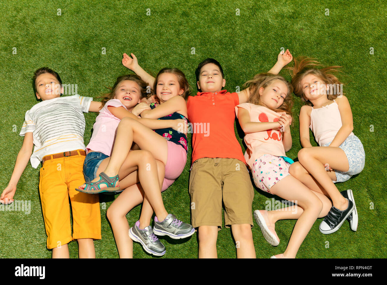 Group of happy children playing outdoors. Kids having fun in spring ...
